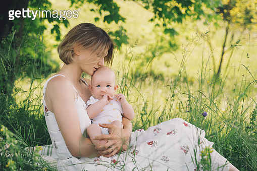 Beautiful mother and baby on nature. Young woman with her baby in ...