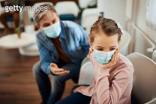 Little girl feeling nervous before dental exam while sitting with her ...