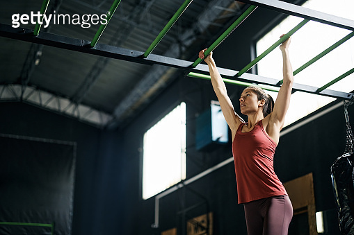 Young athlete doing gym ladder monkey walk during her sports training ...