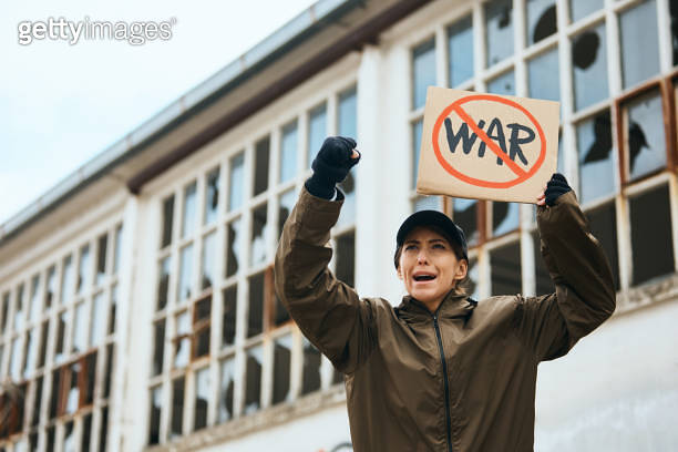 Angry female activist shouting on anti-war protest on war ravaged ...