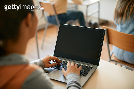 Close-up of high school student e-learning on laptop during computer ...