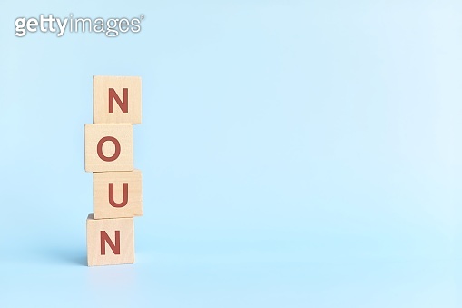 Noun concept in English grammar education. Wooden block crossword ...