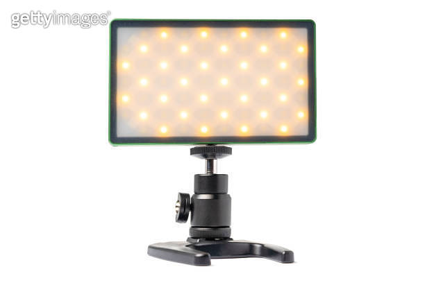 Portable on-camera LED panel for video shooting with a lamp on a tripod ...