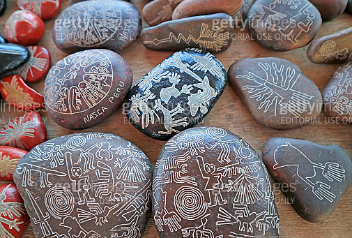 Heap of souvenirs of Nazca lines carved into the various size of pebble ...