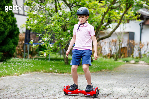 Active kid boy on hover board. Child driving modern balance hoverboard ...