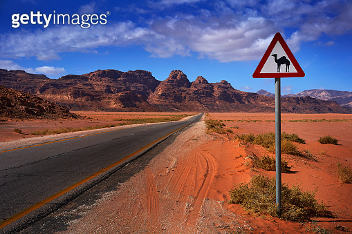 Jordan Travel. Traffic road sign with camel near the asphalt road. Wadi ...