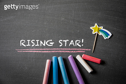 Rising Star. Text and colored pieces of chalk on a blackboard 이미지 ...