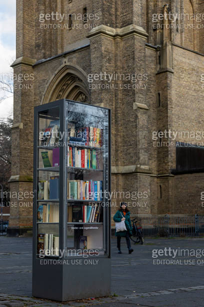 Miniature public library booth in front of a church in Cologne on a ...