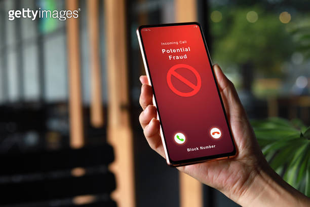 Person receiving a potential fraud call on smartphone from an unknown ...