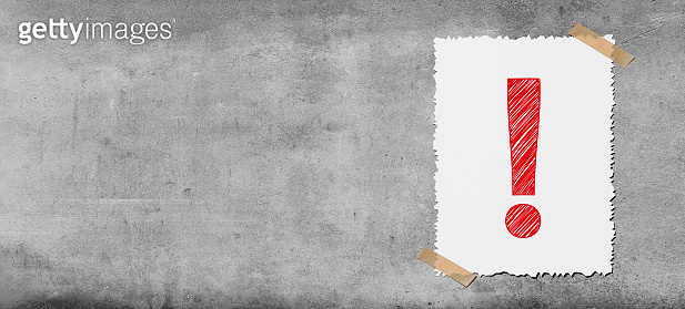 Note paper with exclamation mark on textured concrete wall background ...