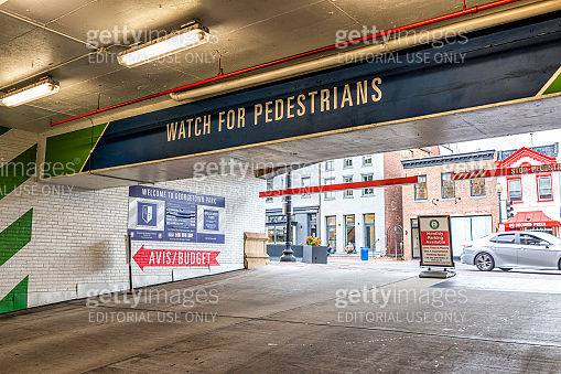 Georgetown M street with sign inside public parking garage exit for ...
