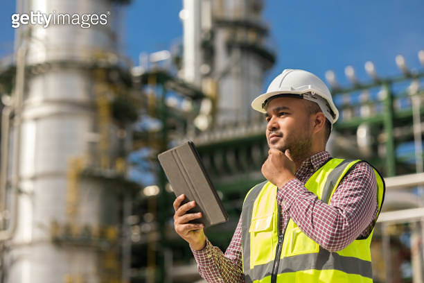 Asian engineer handsome man use tablet with white safety helmet ...