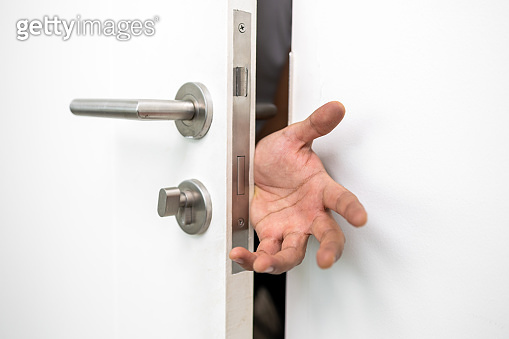 Hand clamped door. A young man shut the door of the house so carelessly ...