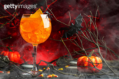 Halloween aperol spritz cocktail on scary dark bloody red background ...