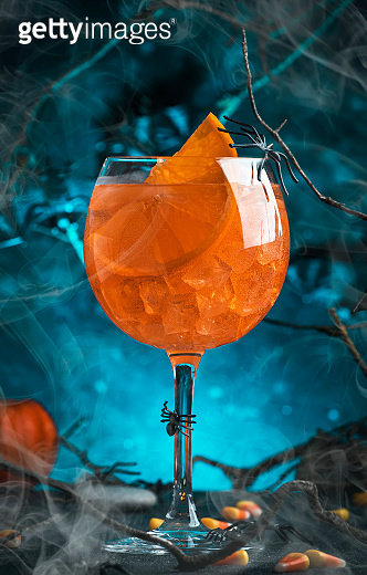 Halloween Spritz cocktail on scary dark blue background with twisted ...