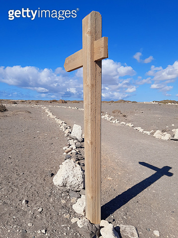 Side view of wooden post with directional arrow indicating path in ...