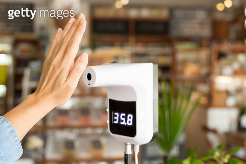 Close up of woman's hand raised to white contactless digital ...