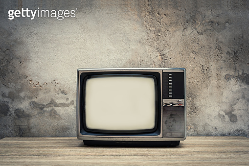 Retro old television on wood table with old concrete wall background ...