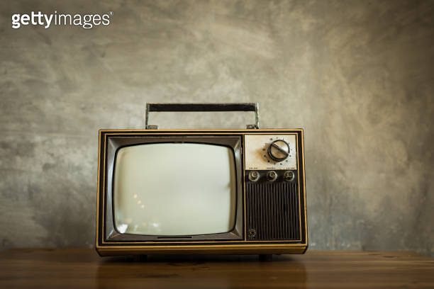 Vintage old television on wooden table with concrete wall background ...