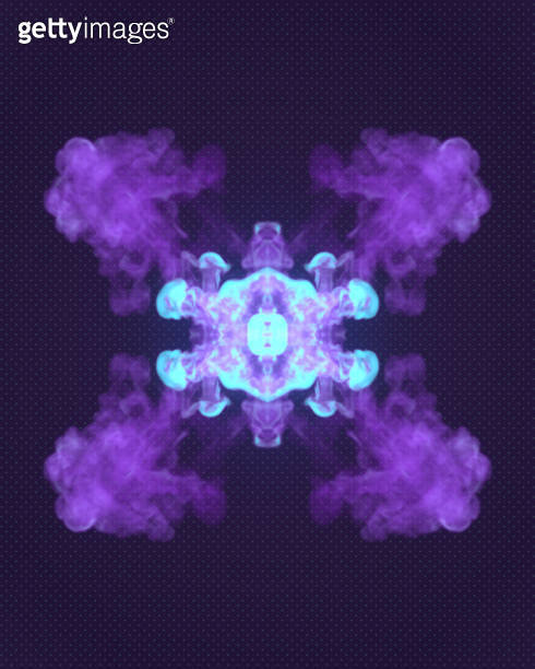 Explosion with neon colored chemical smoke on dark background. Abstract kaleidoscopic pattern ...