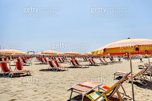 Beach chairs and sunbathers along the shores of the Mediterranean north ...