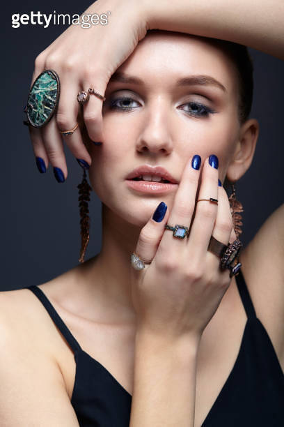 Young woman with many bijouterie rings with stones on fingers 이미지 ...