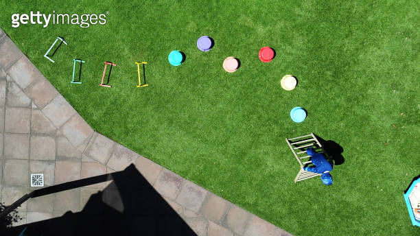 Backyard Obstacle Course - Family fitness at home. Young boy exercising ...