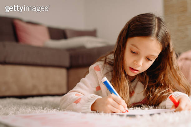 Close up photo of a child with long blond hauir seriosly and ...