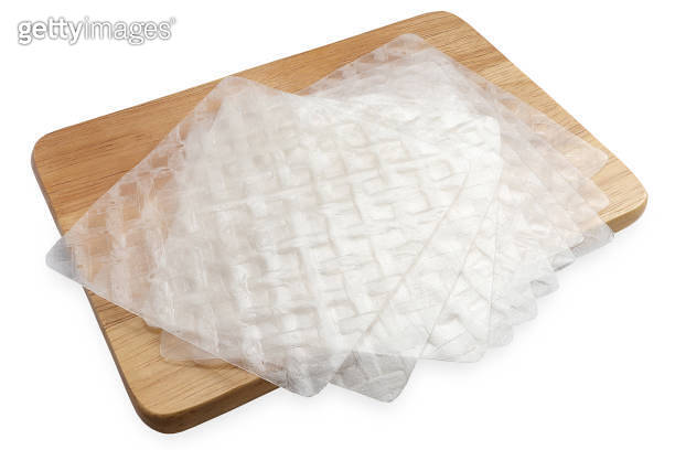 Vietnamese dry rice paper. stack of dried rice paper sheets on wooden ...