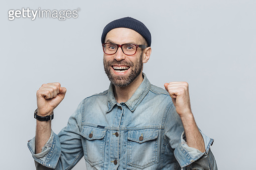 Portrait of happy successful man rejoices his triumph, clenches teeth ...