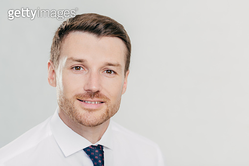 Portrait of attractive male CEO with confident facial expression, looks ...