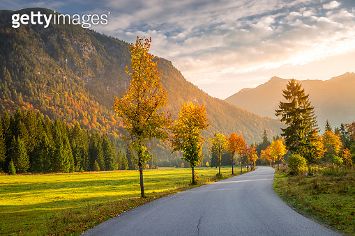 Country road in Alps at dramatic autumn sunrise, Karwendel mountains ...