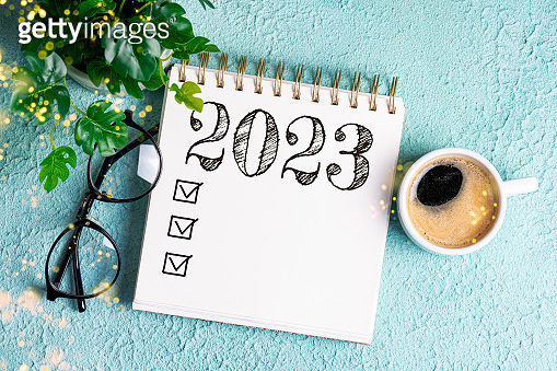 New year goals 2023 on desk. 2023 goals list with notebook, coffee cup ...