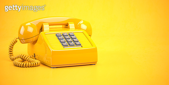 Yellow telephone. Vintage retro push button telephone on yellow ...