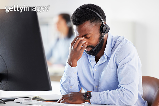 One stressed young african american male call centre agent getting a ...