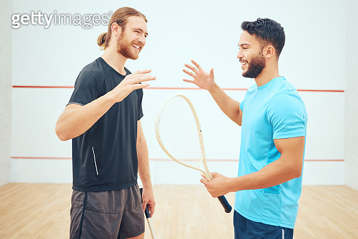 Two athletic squash players shaking hands before court game. Team of ...