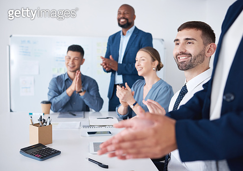 Diverse group of smiling business people clapping during boardroom ...