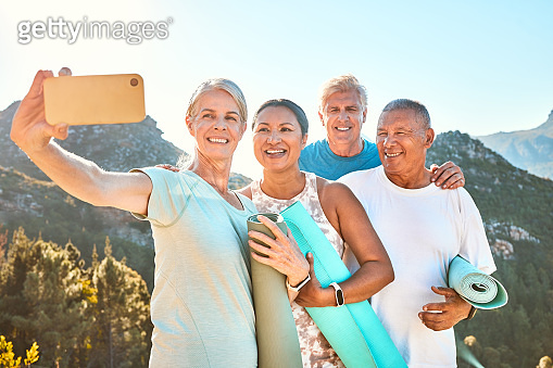 Group of active seniors posing together for a selfie or video call on a ...