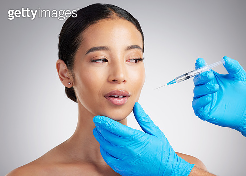 A gorgeous mixed race young woman getting botox filler. Hispanic model ...