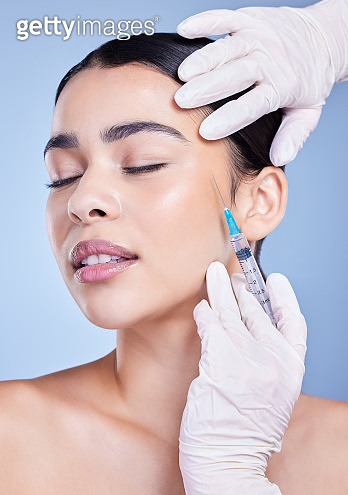 A gorgeous mixed race woman getting botox filler in her face. Hispanic ...
