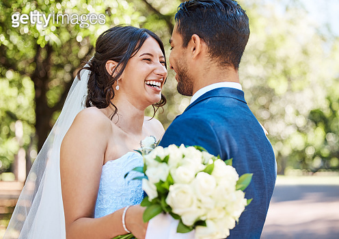 Happy young couple on their wedding day. Husband and wife standing face ...