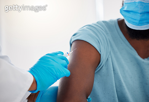 Hand of a doctor holding a needle with the vaccine. The covid vaccine ...