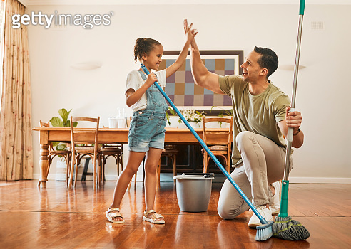 Adorable little girl helping her father sweep and mop wooden floors for ...