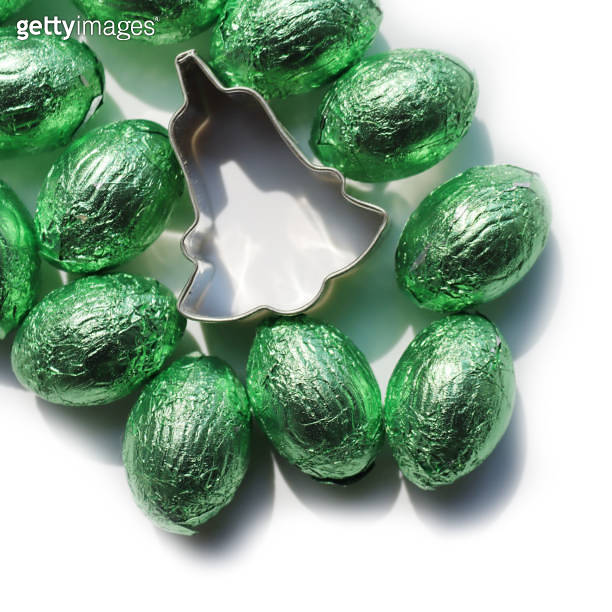 Chocolate easter eggs in green foil with Easter bell shape cookie ...