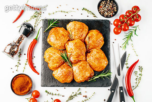 Top view.chicken thighs marinated in red sauce on a kitchen cutting ...