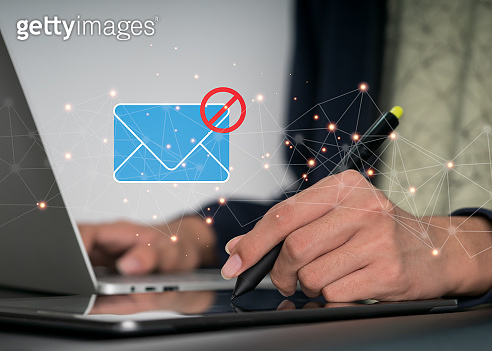 Businesswoman working on laptop computer at home with warning window on ...