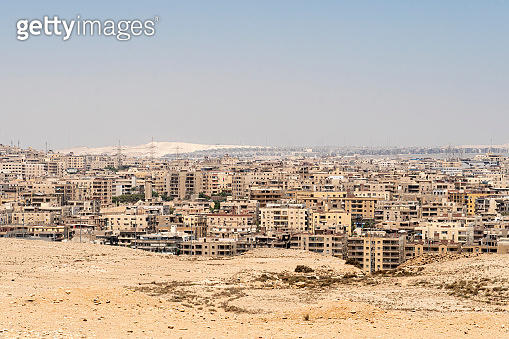 view of Cairo of red brick houses from the Giza pyramid complex, Giza ...