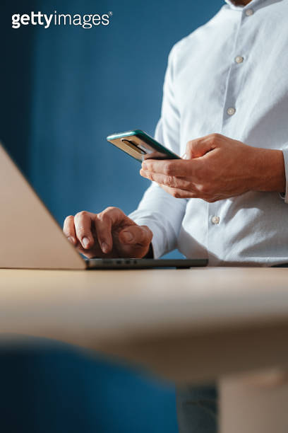 Low Angle View Of An Anonymous Businessman Using A Mobile Phone At Home ...