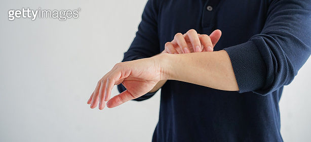 close up man scratch on arm after feeling uncomfortable from allergy ...