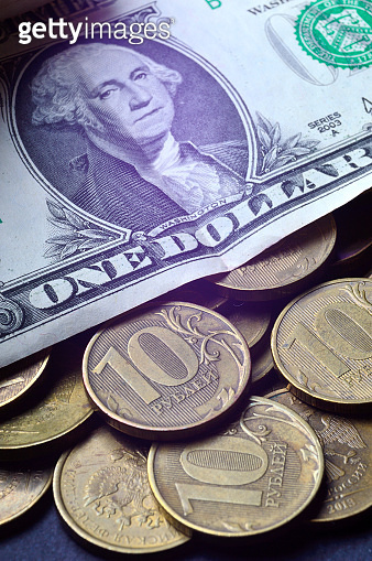 The American dollar on top of which lie Russian coins with a face value ...